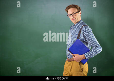 Composite image of geeky student holding a notebook Stock Photo - Alamy
