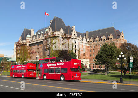 Double-decker tour buses line up in front of the regal Empress Hotel, a ...