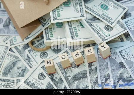Wooden blocks - the inscription money. a lot of money out of a paper ...
