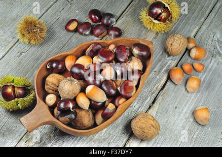 Walnuts, chestnuts and hazelnuts on a wooden table Stock Photo - Alamy