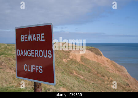 Warning sign post for dangerous cliffs, Filey Brigg, North Yorkshire ...