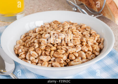 Honey coated puffed wheat breakfast cereal Stock Photo - Alamy