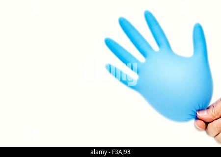 Hand Holding Blown Up Latex Glove Blue Stock Photo - Alamy