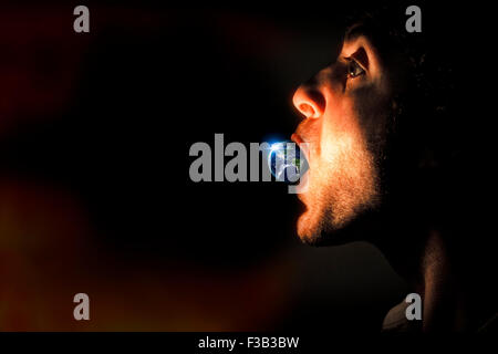 Man eating planet earth, Elements of image from NASA Stock Photo - Alamy
