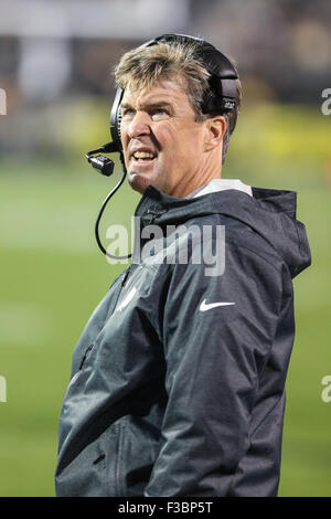 Colorado head coach Mike MacIntyre leads his players onto the field ...