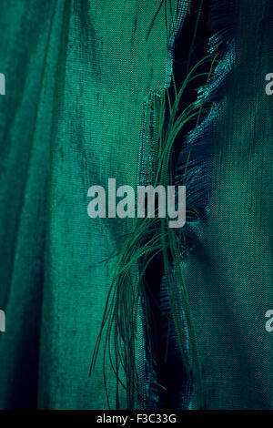 A piece of teal colored ripped silk fabric Stock Photo - Alamy