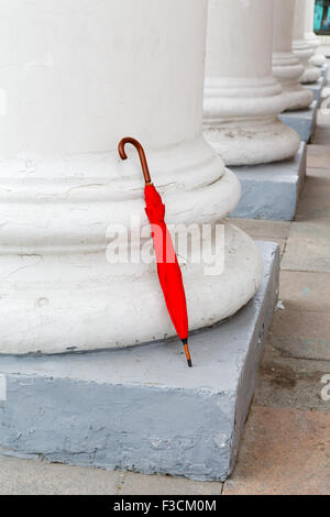 red umbrella near the high column Stock Photo - Alamy