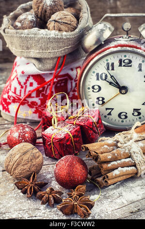Alarm clock with festive decorations on blue background. Christmas ...