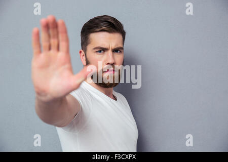Man Showing Stop Sign Over White Background Stock Photo - Alamy