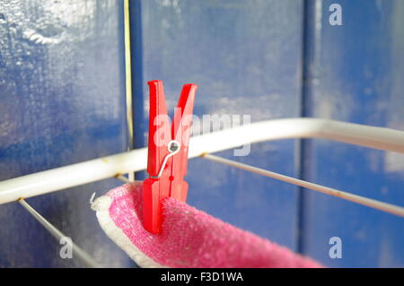 White paper clouds and red textile hearts on a red background ...