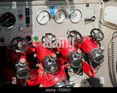 Rear of a fire engine showing the water pump outlets and hose ...