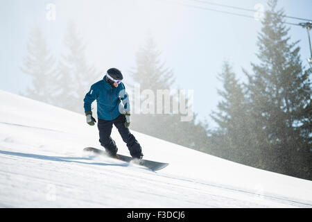 Man snowboarding downhill Stock Photo - Alamy