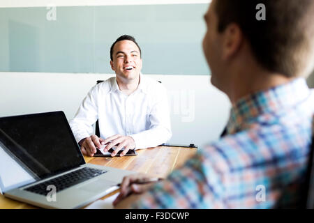 Man being interviewed in conference room Stock Photo - Alamy