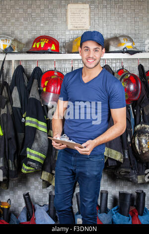 Confident Firefighter Holding Clipboard At Fire Station Stock Photo - Alamy