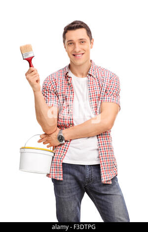 Young male decorator with paintbrush on white color background Stock ...