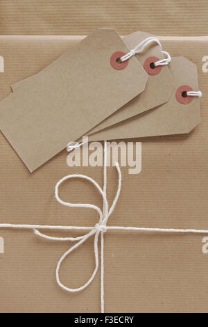 Parcel packing brown parcel paper labels and string Stock Photo - Alamy