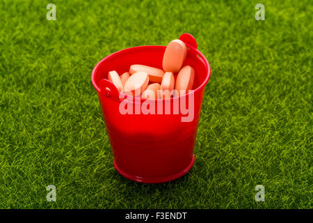 Bucket full of pills Stock Photo - Alamy