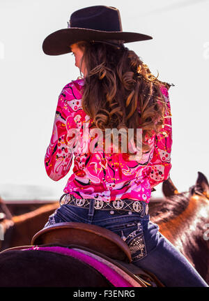 Attractive cowgirl on a horse round-up in the Bighorn Mountains of ...