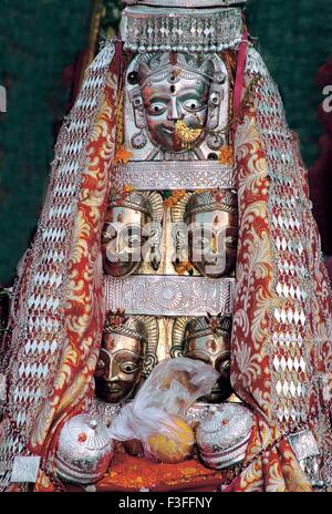 India, Himachal Pradesh, Kulu, Figure of temple god garlanded with ...