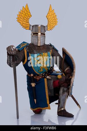 Medieval knight standing on his knee Stock Photo - Alamy