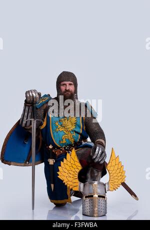 Medieval knight standing on his knee Stock Photo - Alamy