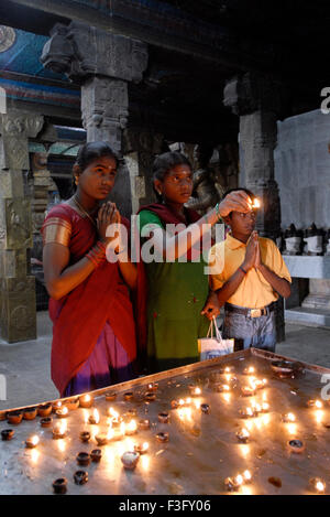 South Indian woman lighting an oil lamp Stock Photo - Alamy
