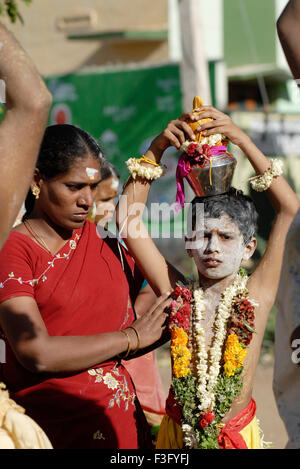 A devotee carrying "Paal Kudam" (milk pot) containing cow's milk as ...