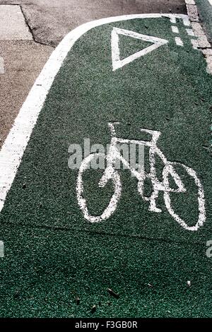 Bicycle road sign with arrow showing direction UK Stock Photo - Alamy