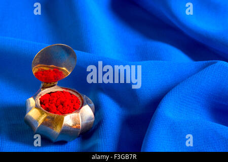 Red sindoor or kumkum or vermillion powder in wooden box on white ...