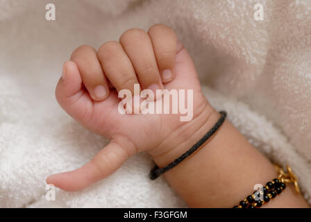Six months old Indian baby girl sucking her fingers Stock Photo - Alamy