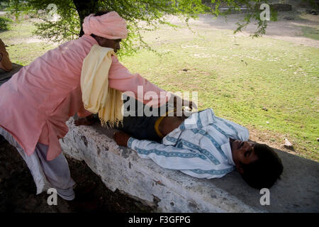 Traditional Indian male of Bheel community performing health check-up ...