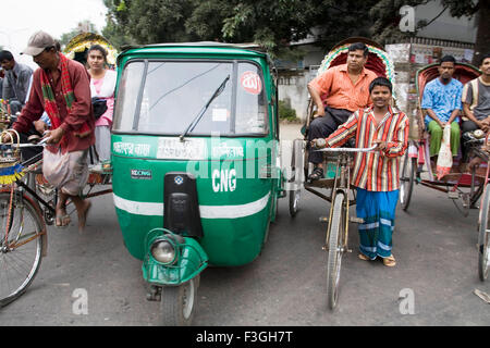 Cycle rickshaw, and auto rickshaw, and passengers caught up in heavy ...