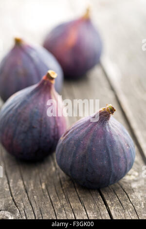 Fresh ripe figs on the table on a dark background close up. Top view ...