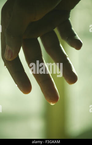 Water dripping from wet fingers Stock Photo - Alamy