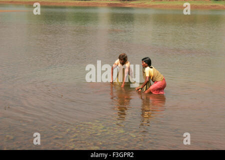 Maharashtrian poor couple trying to do fishing in lake for their daily ...