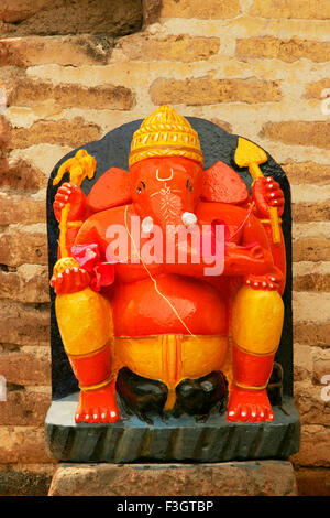 hindu god lord ganesh orange painted statue isolated in a white ...