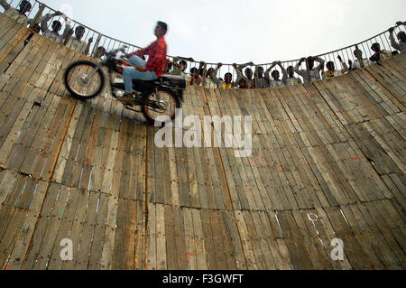 Dare devil performer performing on well of death at annual Pandharpur ...