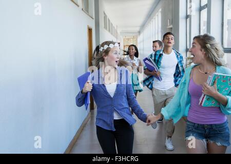 Students running down hallway, laughing Stock Photo - Alamy