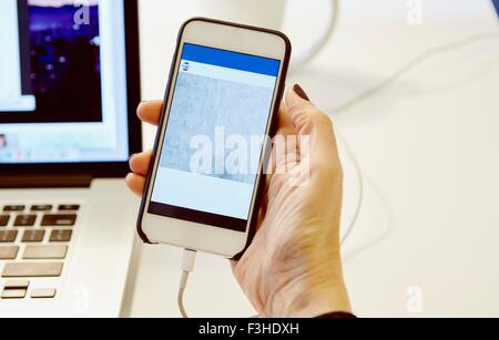 Female hand holding smartphone with UPDATE inscription, modern ...