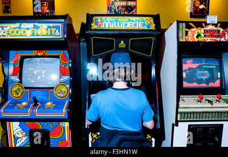 Boy playing vintage video arcade games Stock Photo - Alamy