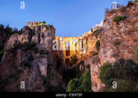 illuminated Puente Nuevo Bridge from outskirts of Ronda at sunset ...