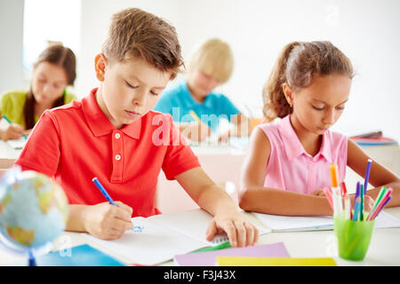 Group of cute pupils drawing in group at lesson Stock Photo - Alamy