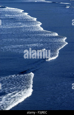 Beautiful view of sea foamy waves splashing against the rocky coast on ...