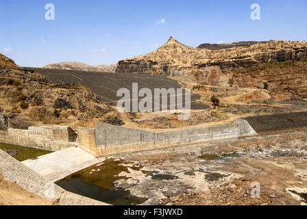 Earthen dam with stone pitching constructed between rock mountains at ...