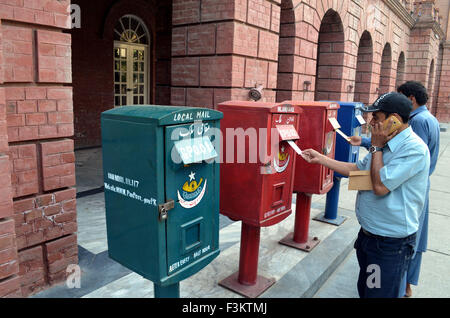Lahore. 9th Oct, 2015. A Pakistani postman collects mails at a post ...