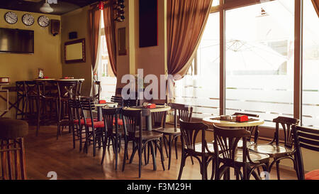Interior of a modern cafe in retro style, night scene. Illumination ...