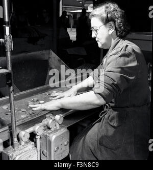 1950s, historical, female factory operative at work making medicines ...