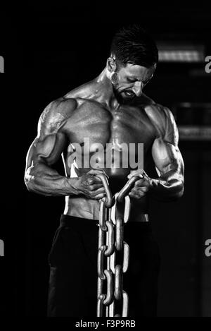 Healthy Bodybuilder Exercising Biceps With Chains Stock Photo - Alamy