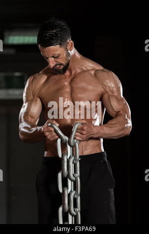 Healthy Bodybuilder Exercising Biceps With Chains Stock Photo - Alamy