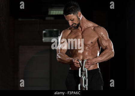 Healthy Bodybuilder Exercising Biceps With Chains Stock Photo - Alamy